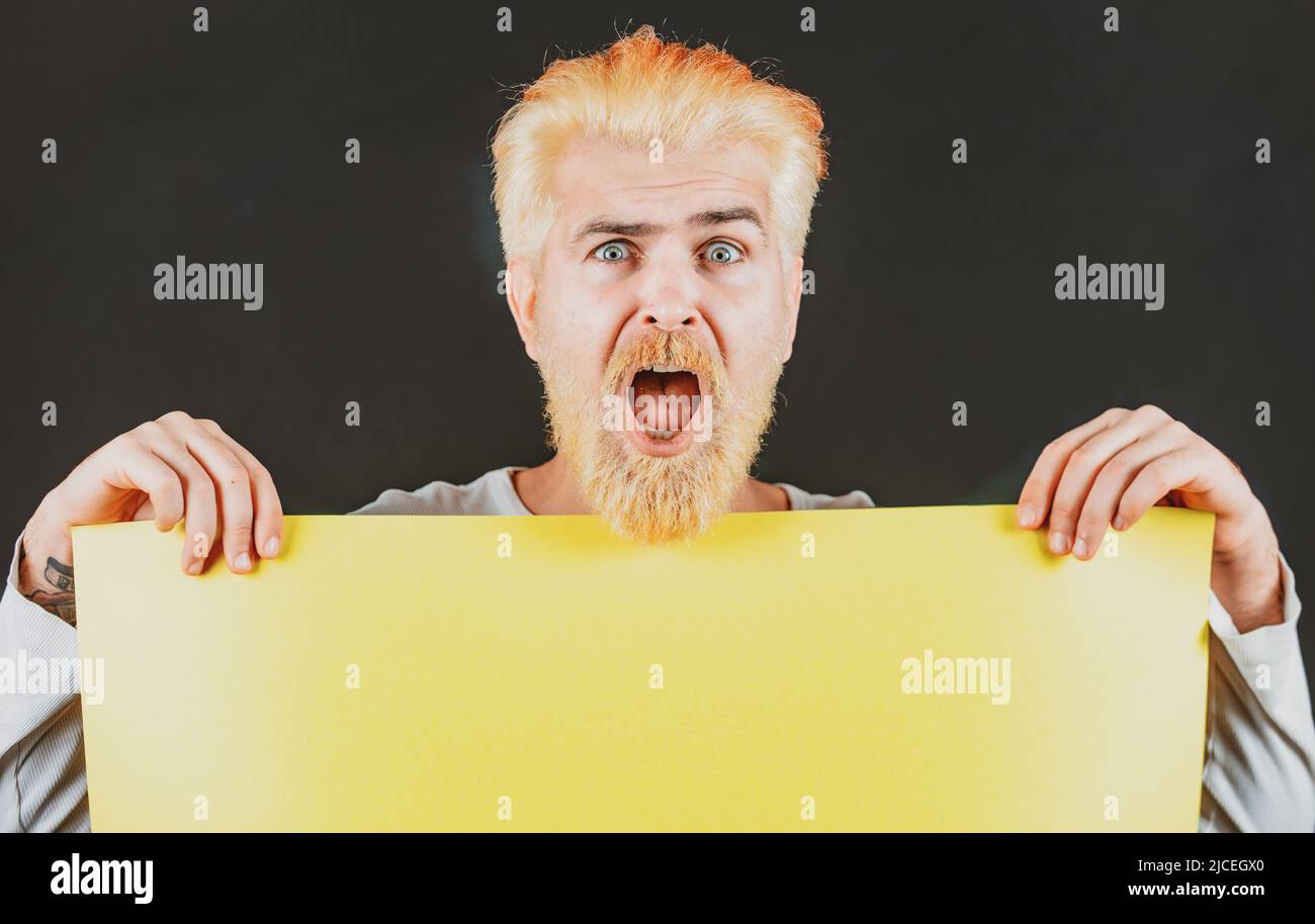 Man holding yellow blank billboard isolated on black background Stock ...