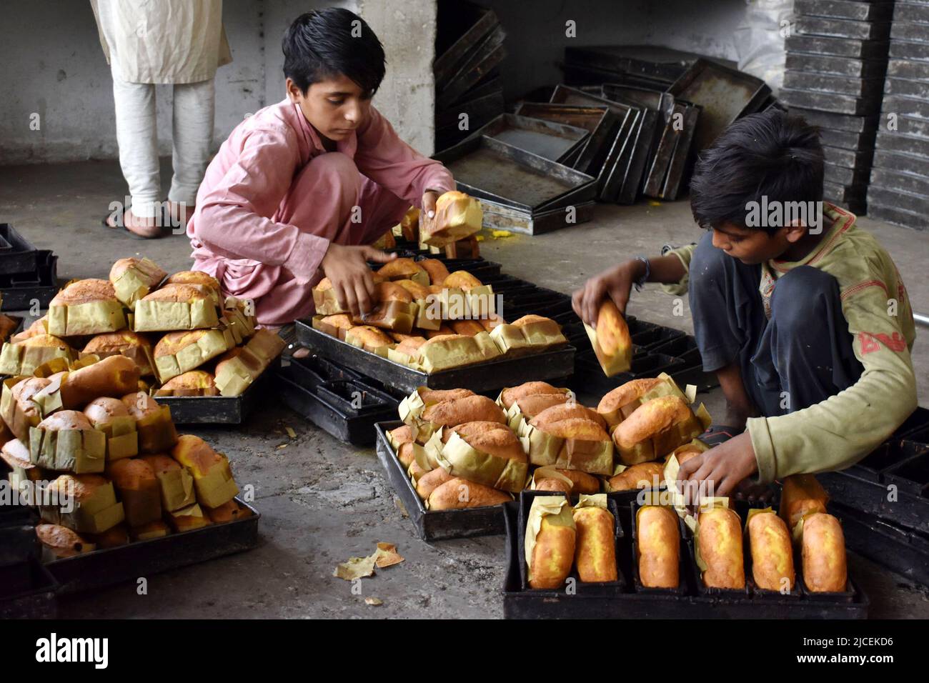 Lahore. 12th June, 2022. Boys work in a bakery on the World Day Against ...
