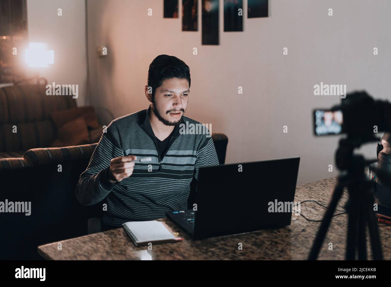 Young teacher teaching online to students. In the background a computer ...