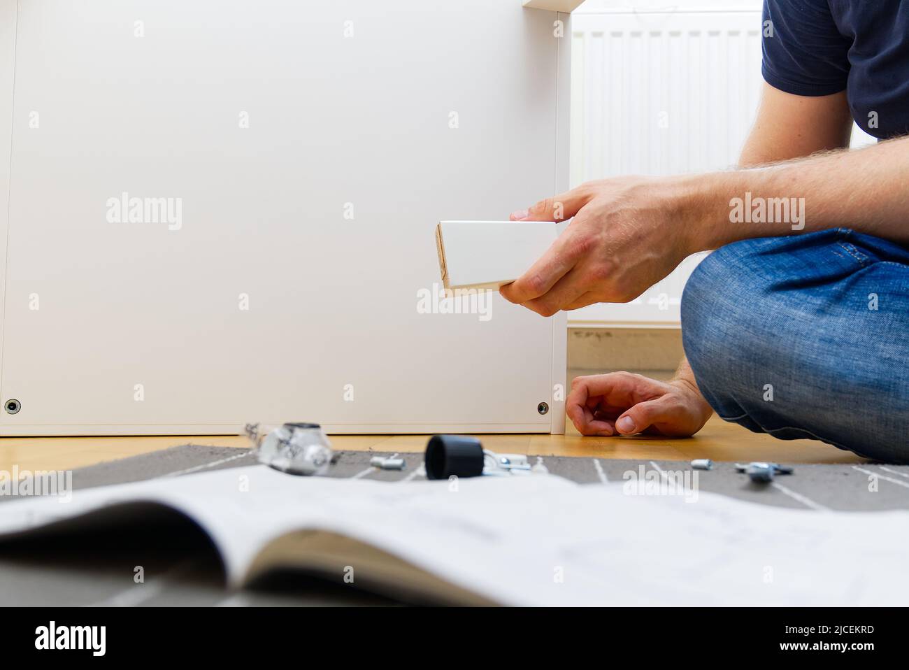 Professional Furniture Assembly Worker Assembles Shelf. Furniture ...