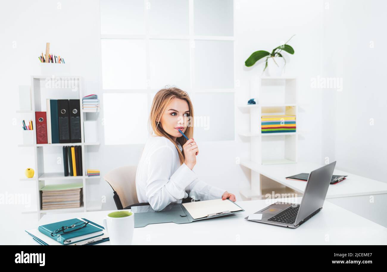 Beauty business woman at office. Gorgeous blond secretary woman writing ...