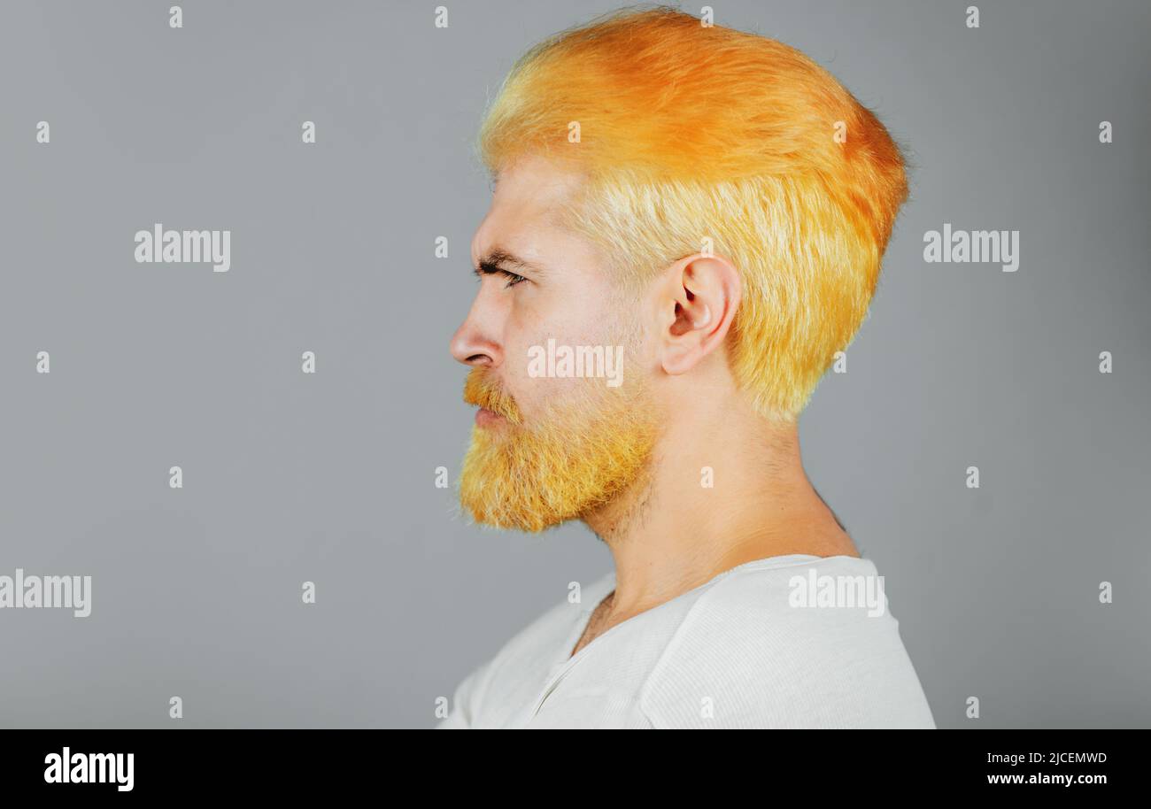 Side profile closeup portrait of serious man. Dyed beard and mustache. Looks seriously, isolated ...