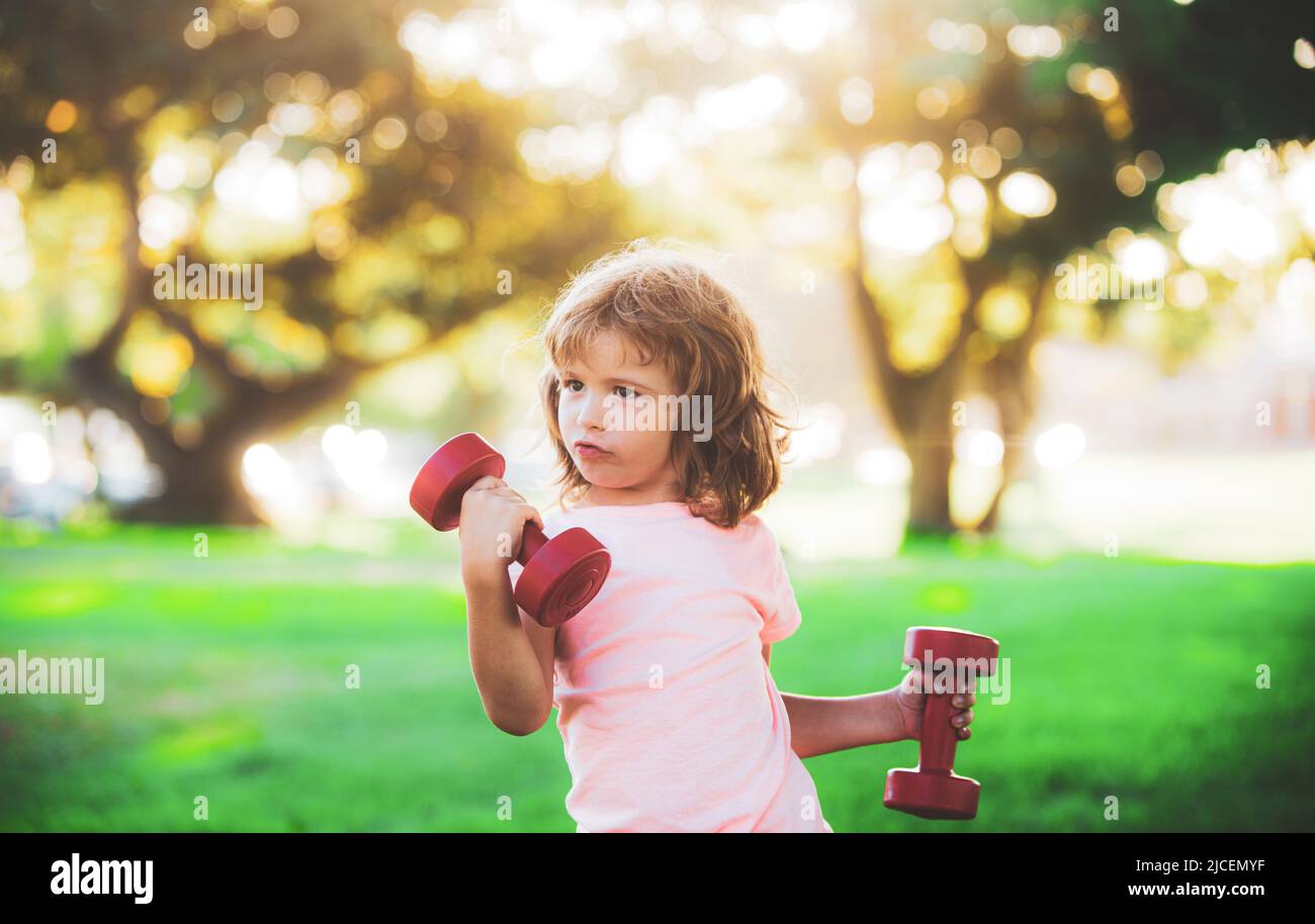 Kids exercising in park. Active boy, healthy lifestyle. Sport child boy with strong biceps ...