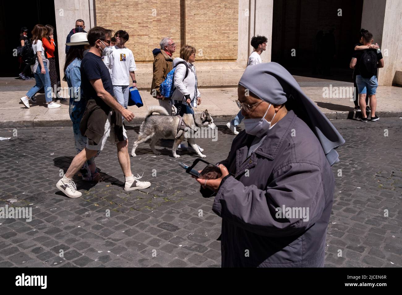 A nun walks the Holy ground. Large crowds at the Easter Sunday mass and ...