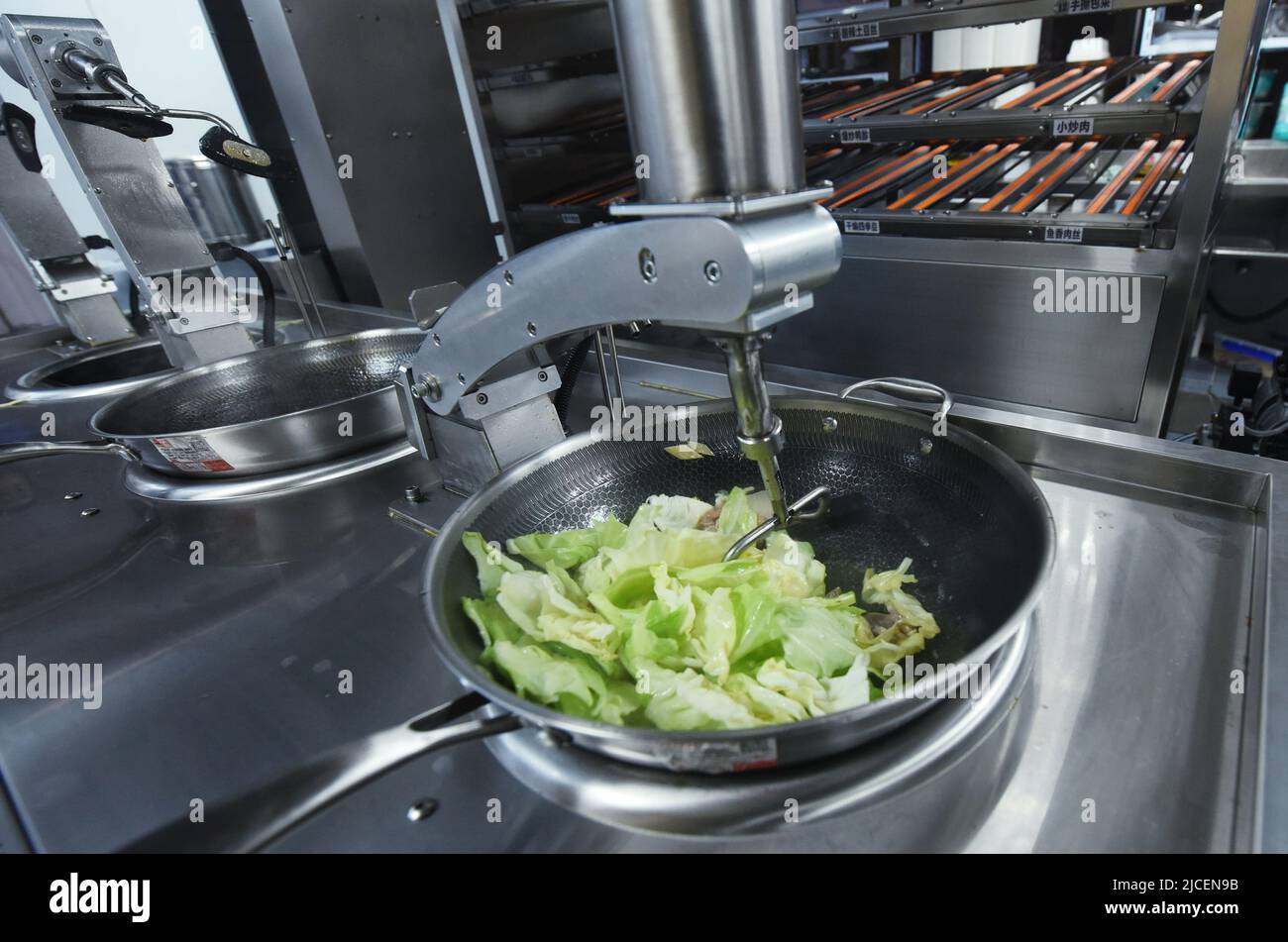 HANGZHOU, CHINA - JUNE 13, 2022 - A stir-frying robot cooks dishes for ...