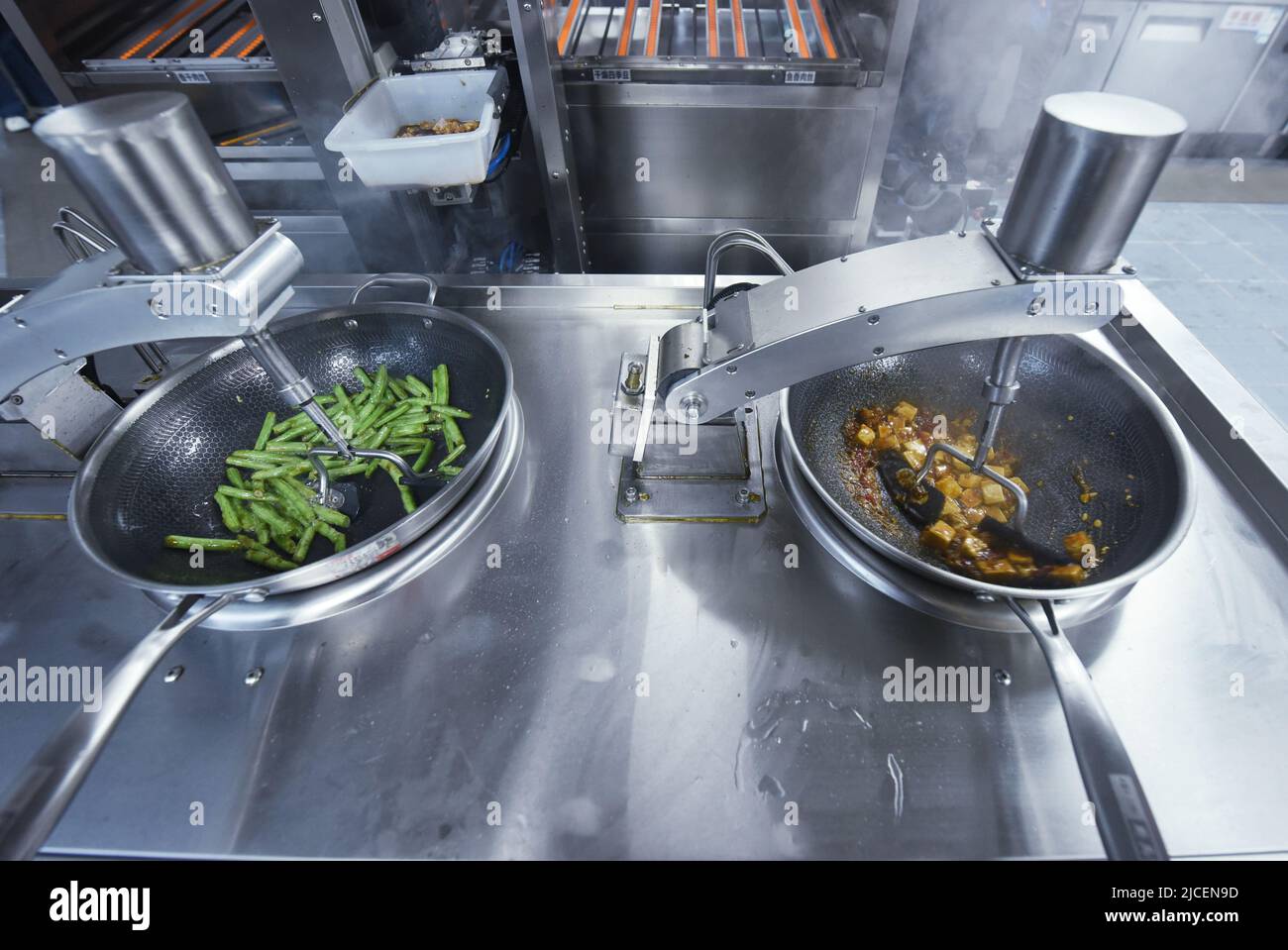 HANGZHOU, CHINA - JUNE 13, 2022 - A stir-frying robot cooks dishes for ...
