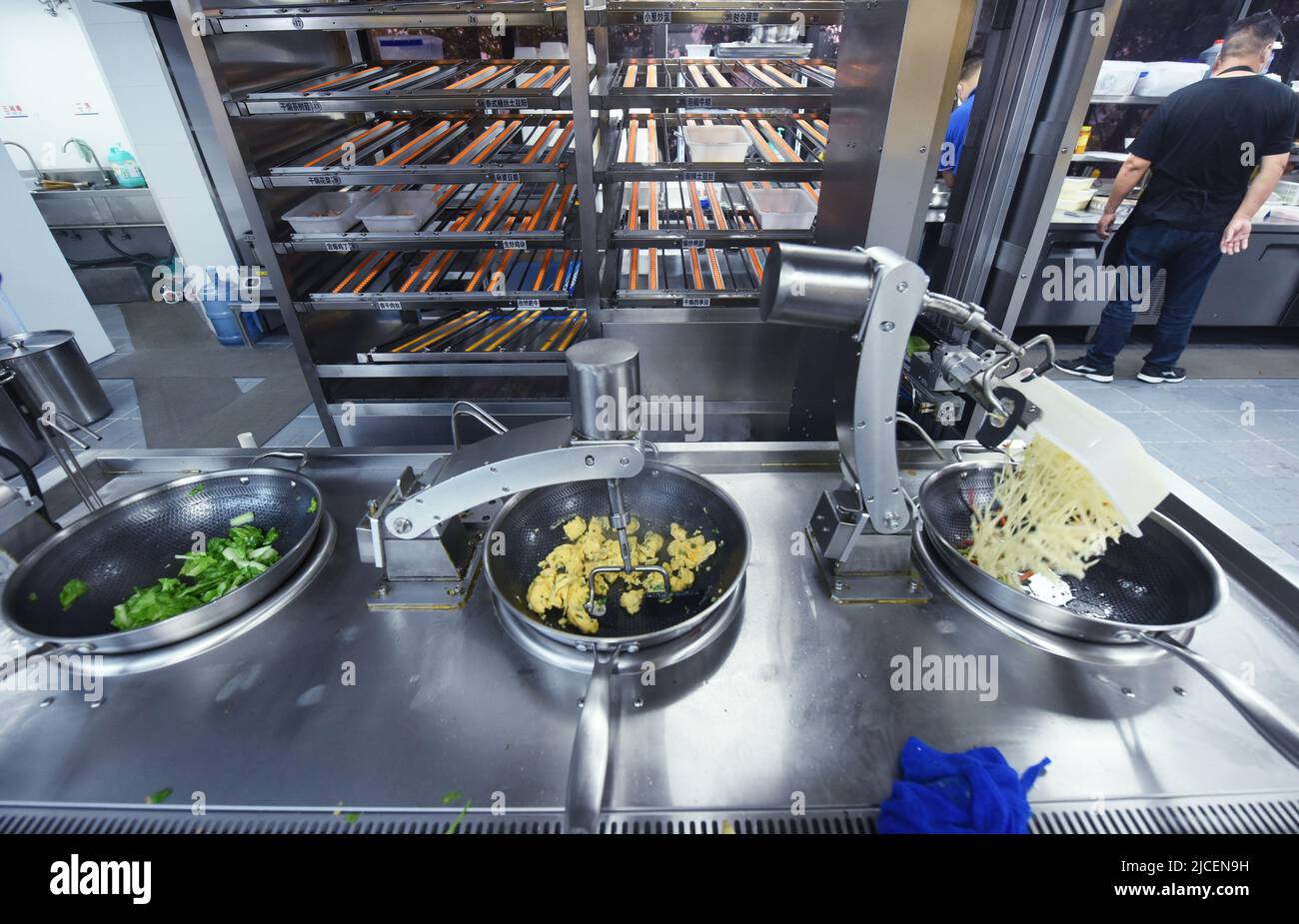HANGZHOU, CHINA - JUNE 13, 2022 - A stir-frying robot cooks dishes for ...