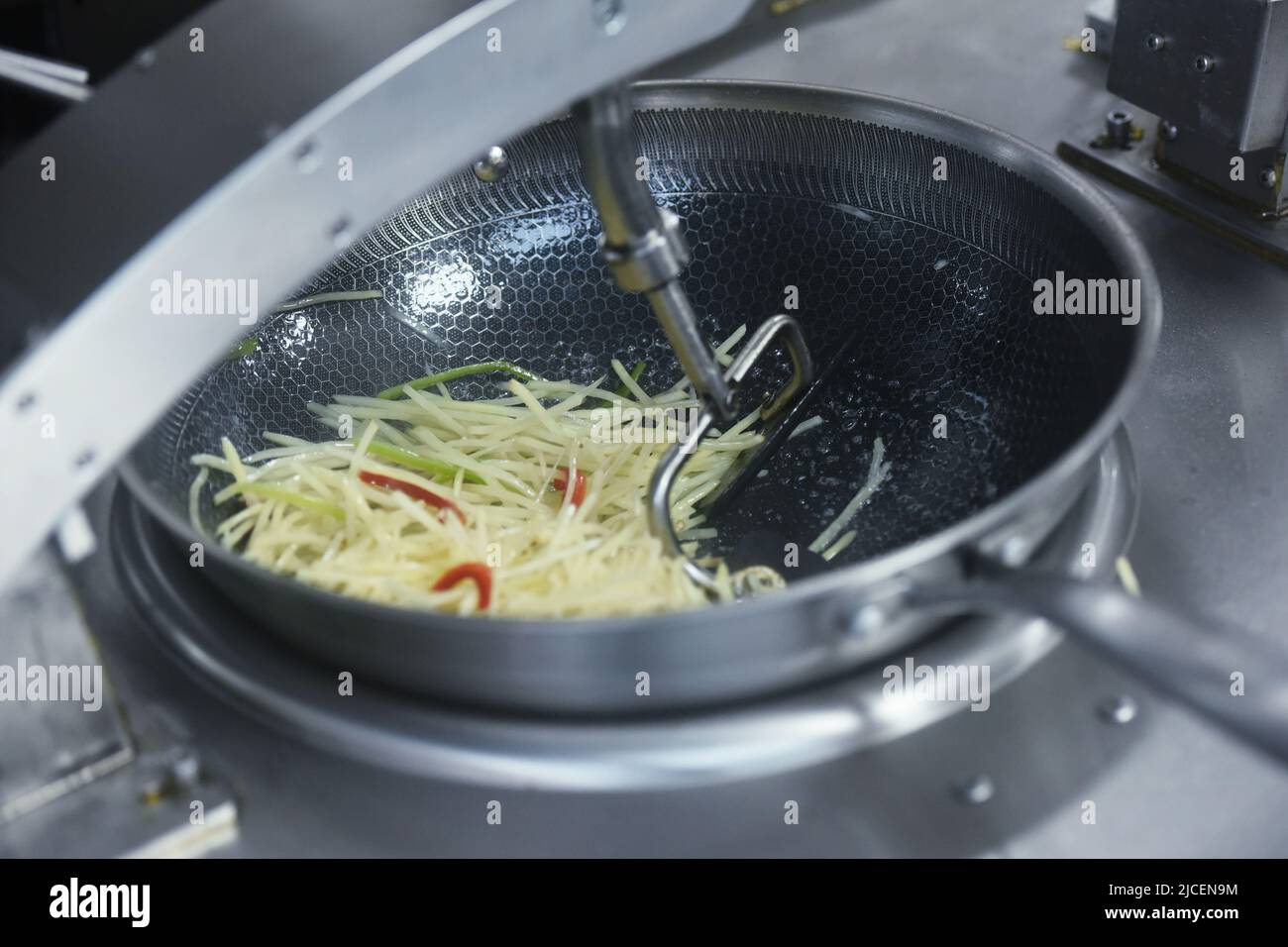 HANGZHOU, CHINA - JUNE 13, 2022 - A stir-frying robot cooks dishes for ...