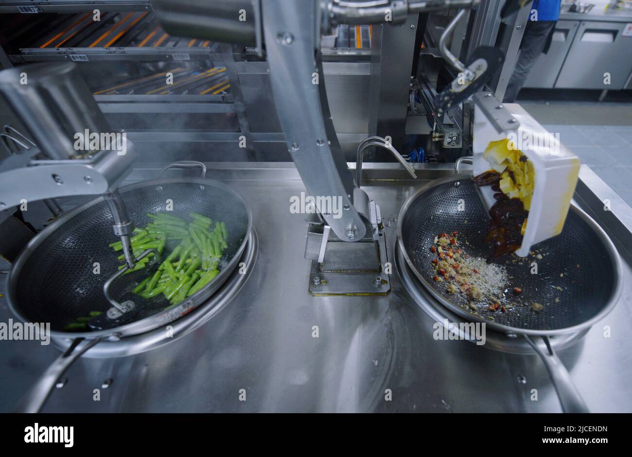 HANGZHOU, CHINA - JUNE 13, 2022 - A stir-frying robot cooks dishes for ...