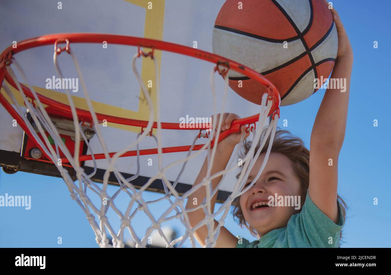 Kid boy basketball player with a ball scoring a goal. Child Player ...