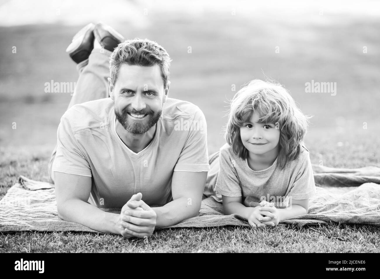 Father and son relaxing on nature in park. Concept of children and ...