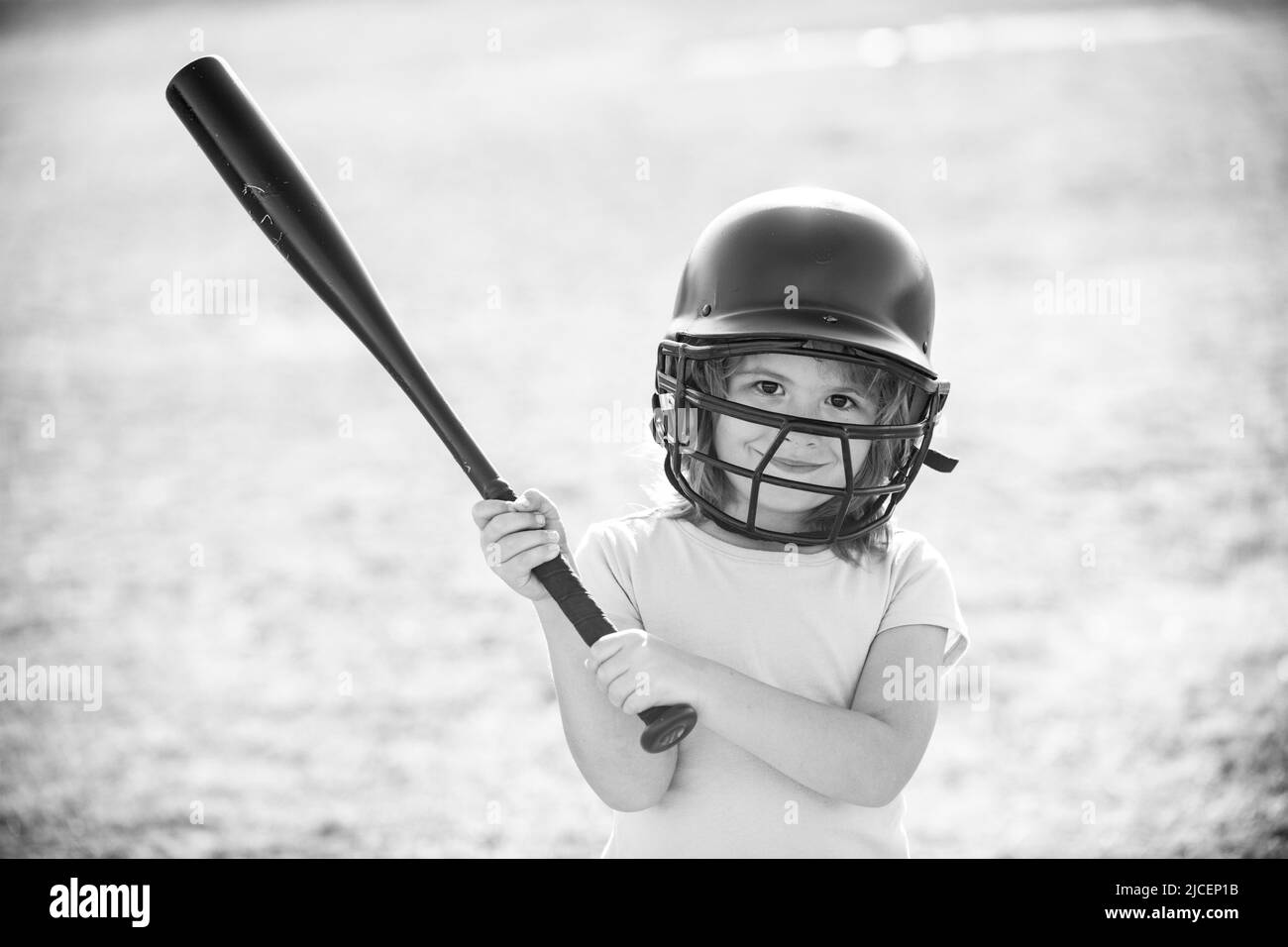 Little child baseball player focused ready to bat. Kid holding a ...