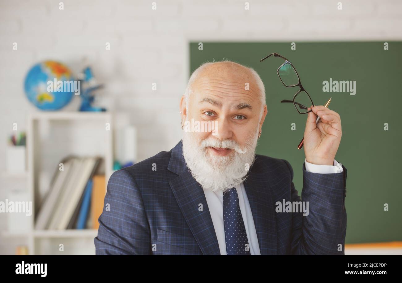Funny professor at school. Teacher smiling in classroom Stock Photo - Alamy