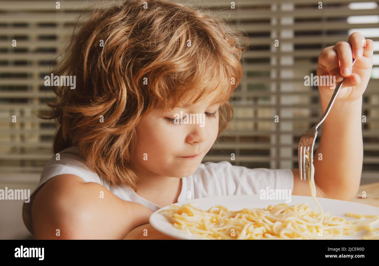 Kid eating pasta, spaghetti, portrait, close up head of cute child ...