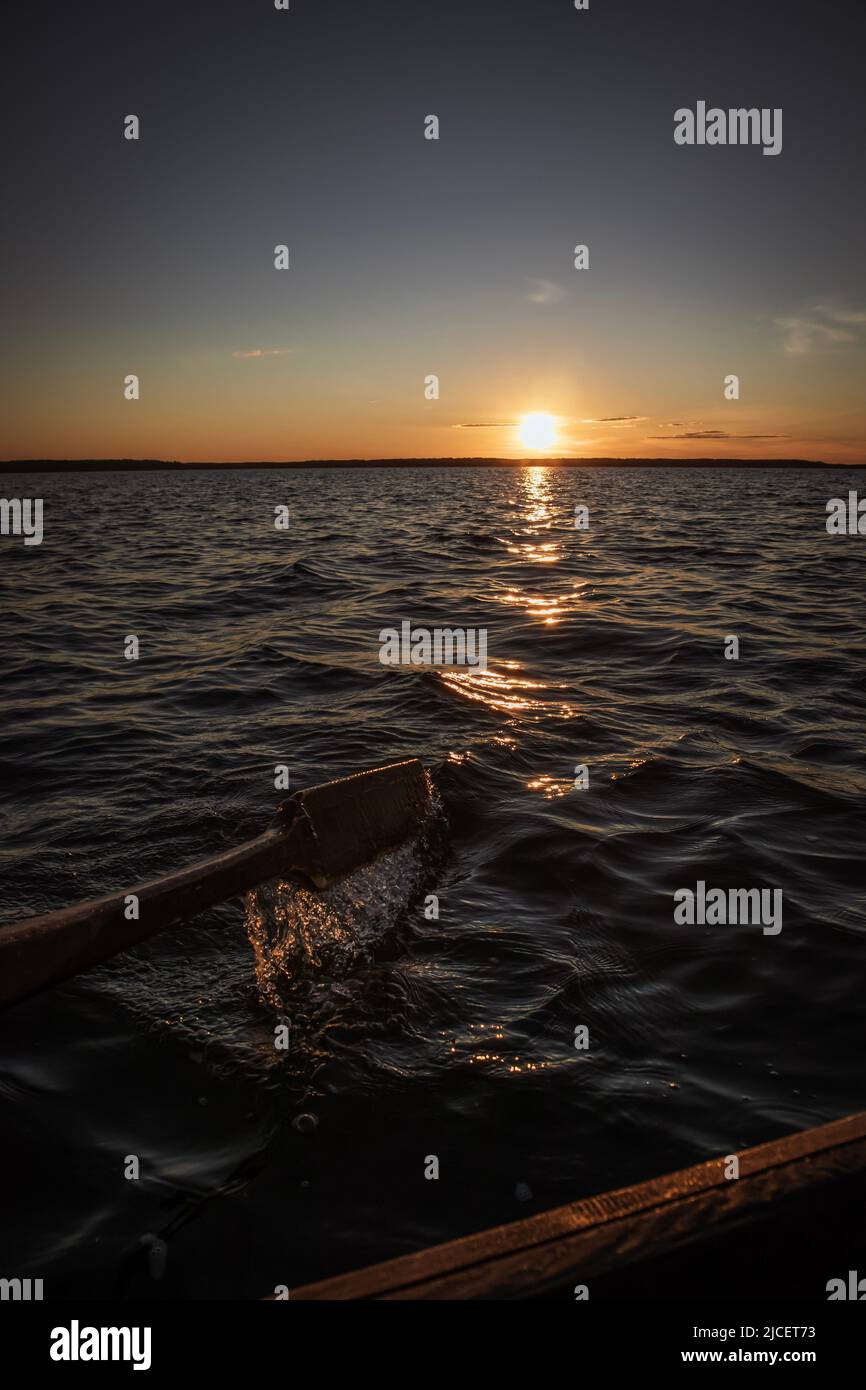 Splash from rowing wooden oar on boat on a lake during sunset Stock ...