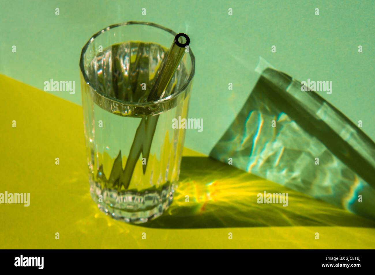 Reusable glass Straws in Glass with water on green background Eco ...