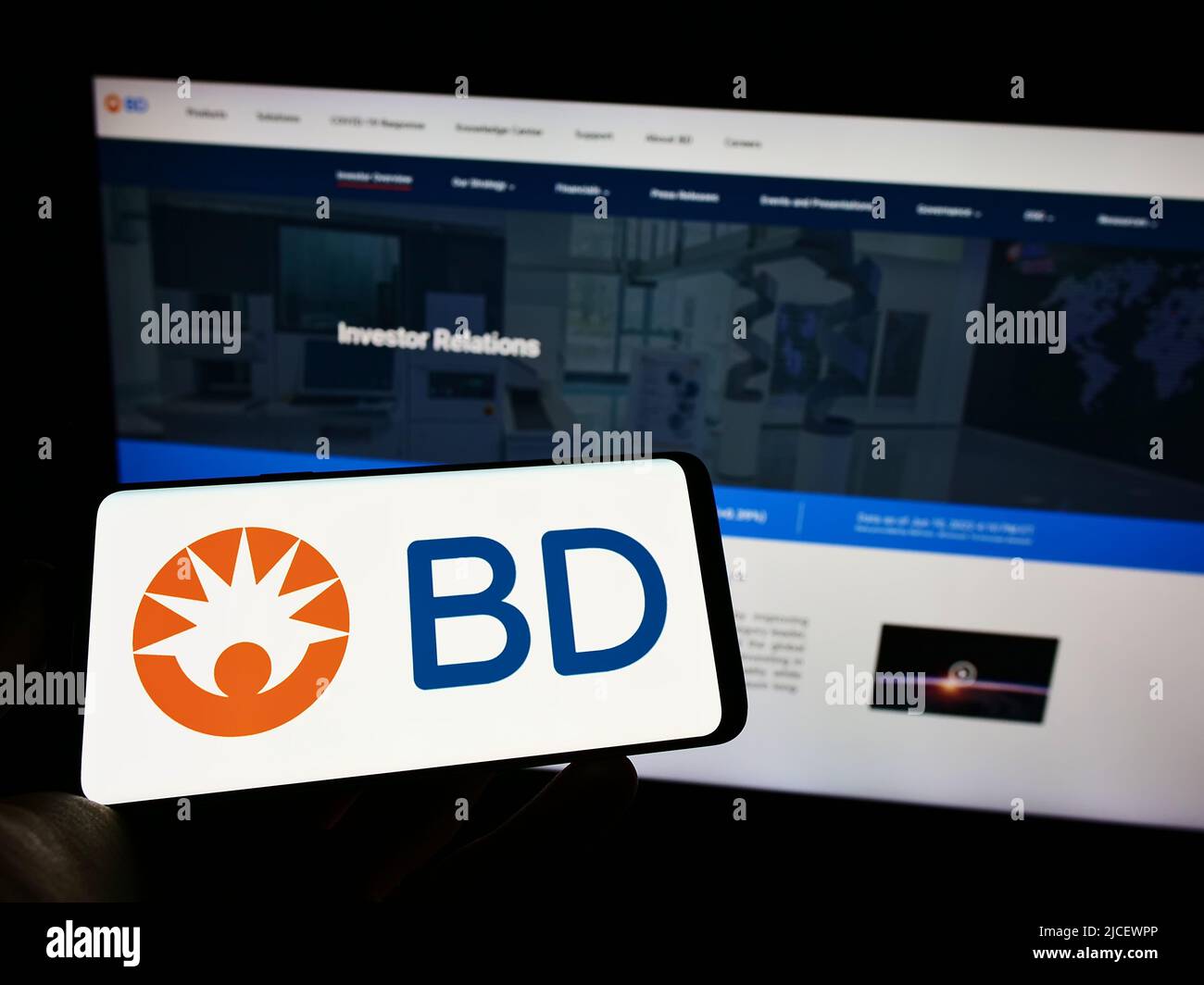 Person holding mobile phone with logo of US medical company Becton ...