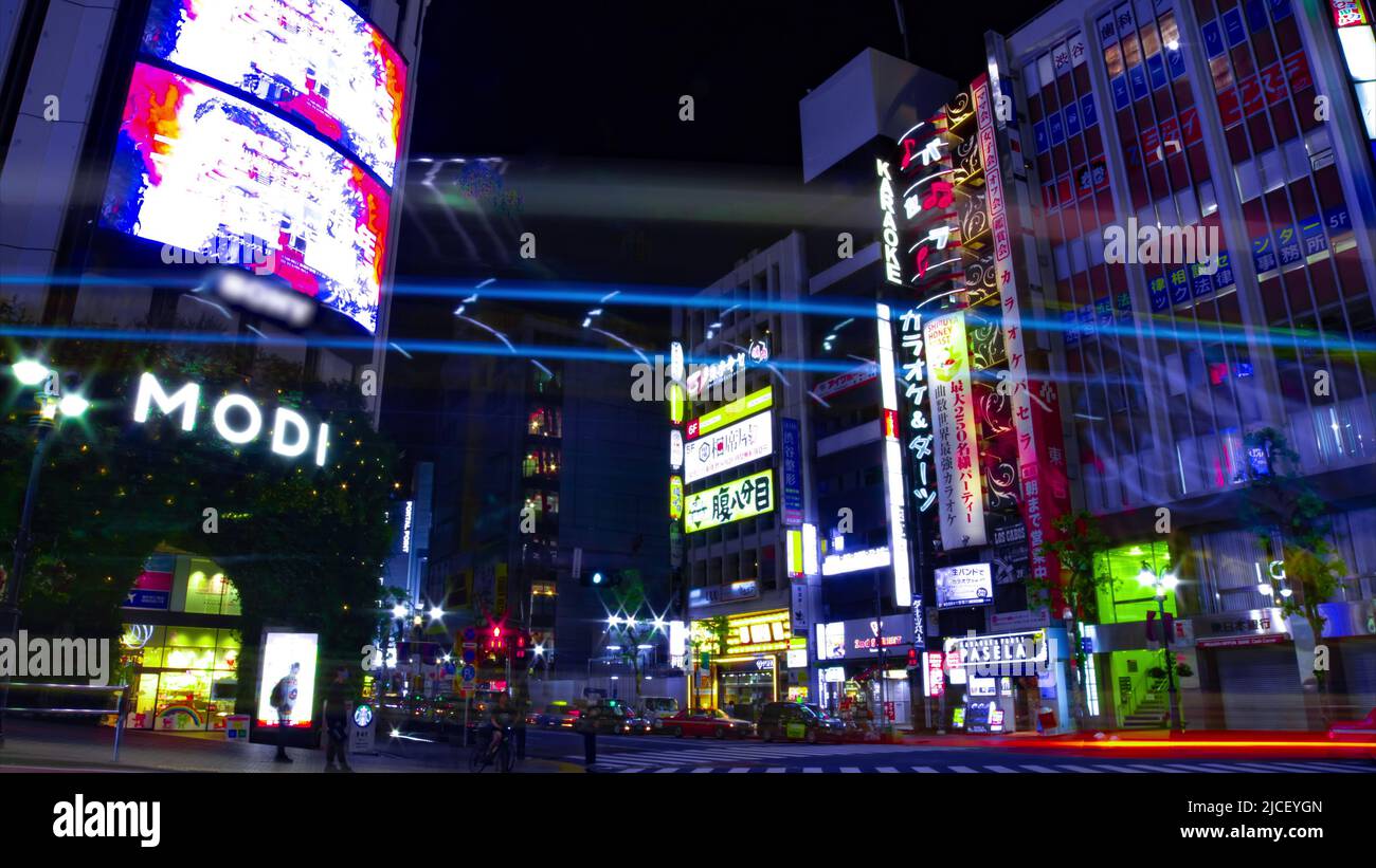 A night timelapse of the neon town in Shibuya Tokyo wide shot tilt ...