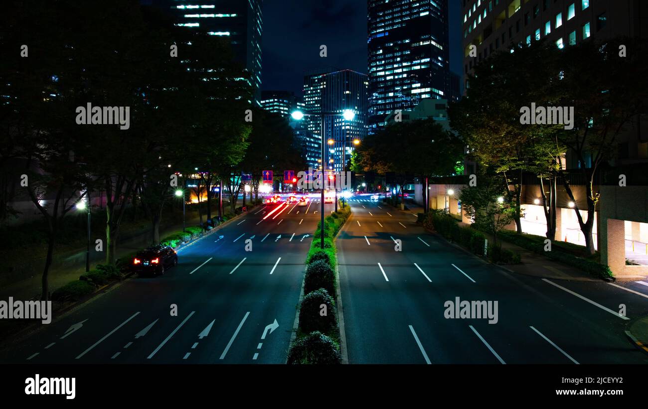 A night timelapse of the urban city street in Shinjuku wide shot tilt ...