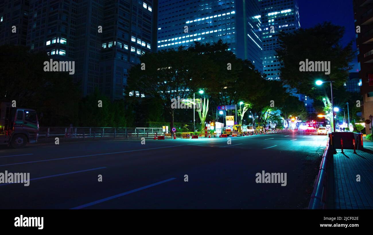 A night timelapse of the urban city street in Shinjuku wide shot tilt ...