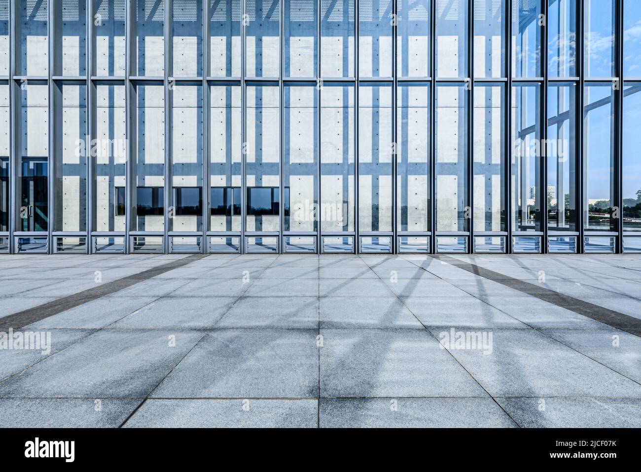 Empty square floor and glass wall building background Stock Photo - Alamy