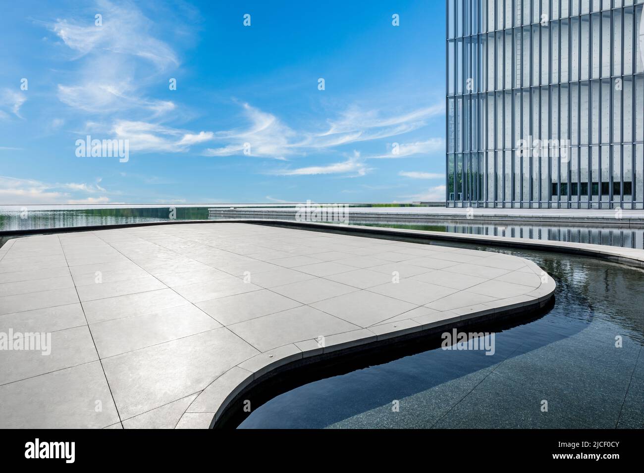 Empty square platform and glass wall building with sky cloud background ...