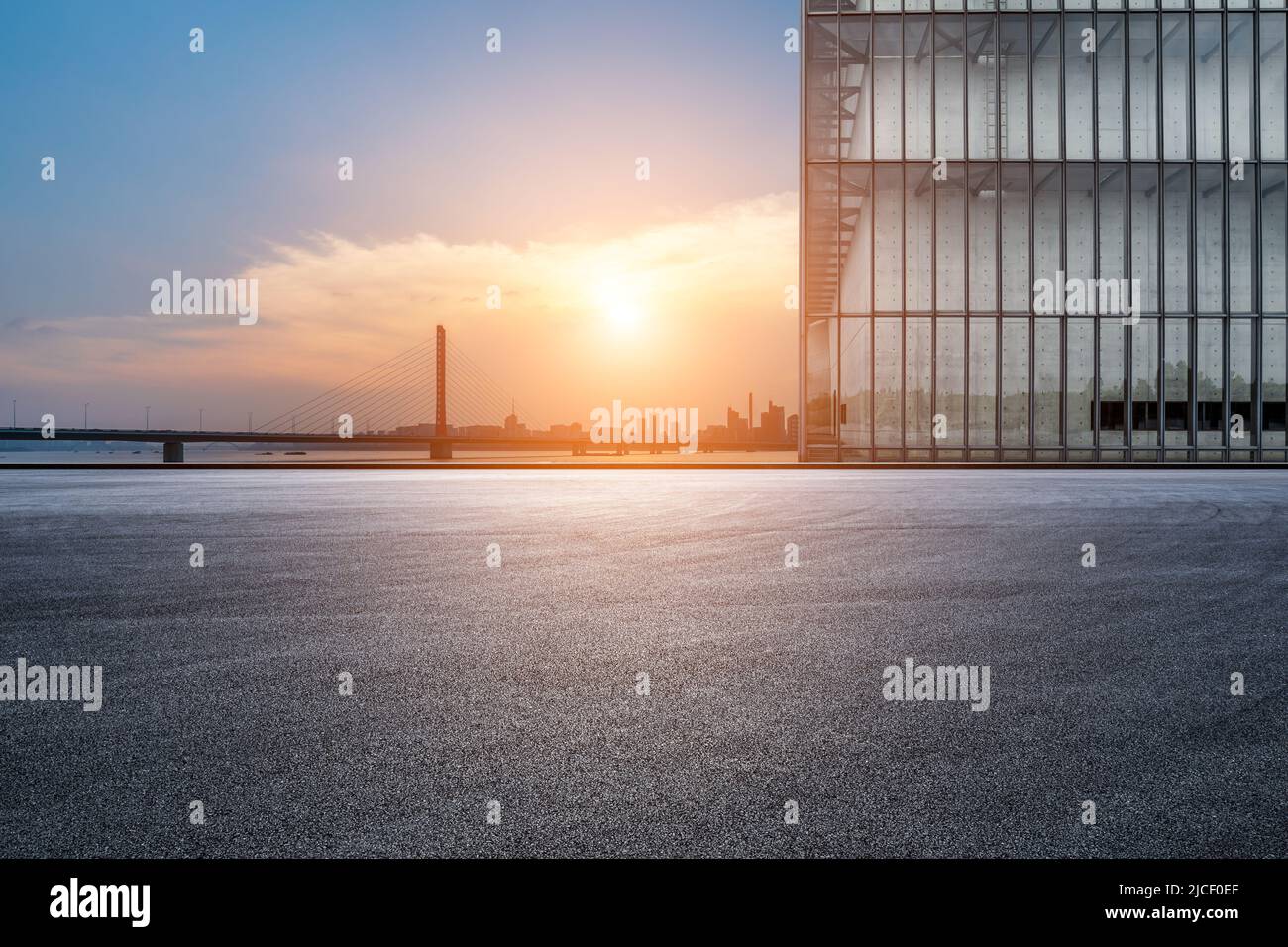 Asphalt road and modern office building with bridge architectural ...