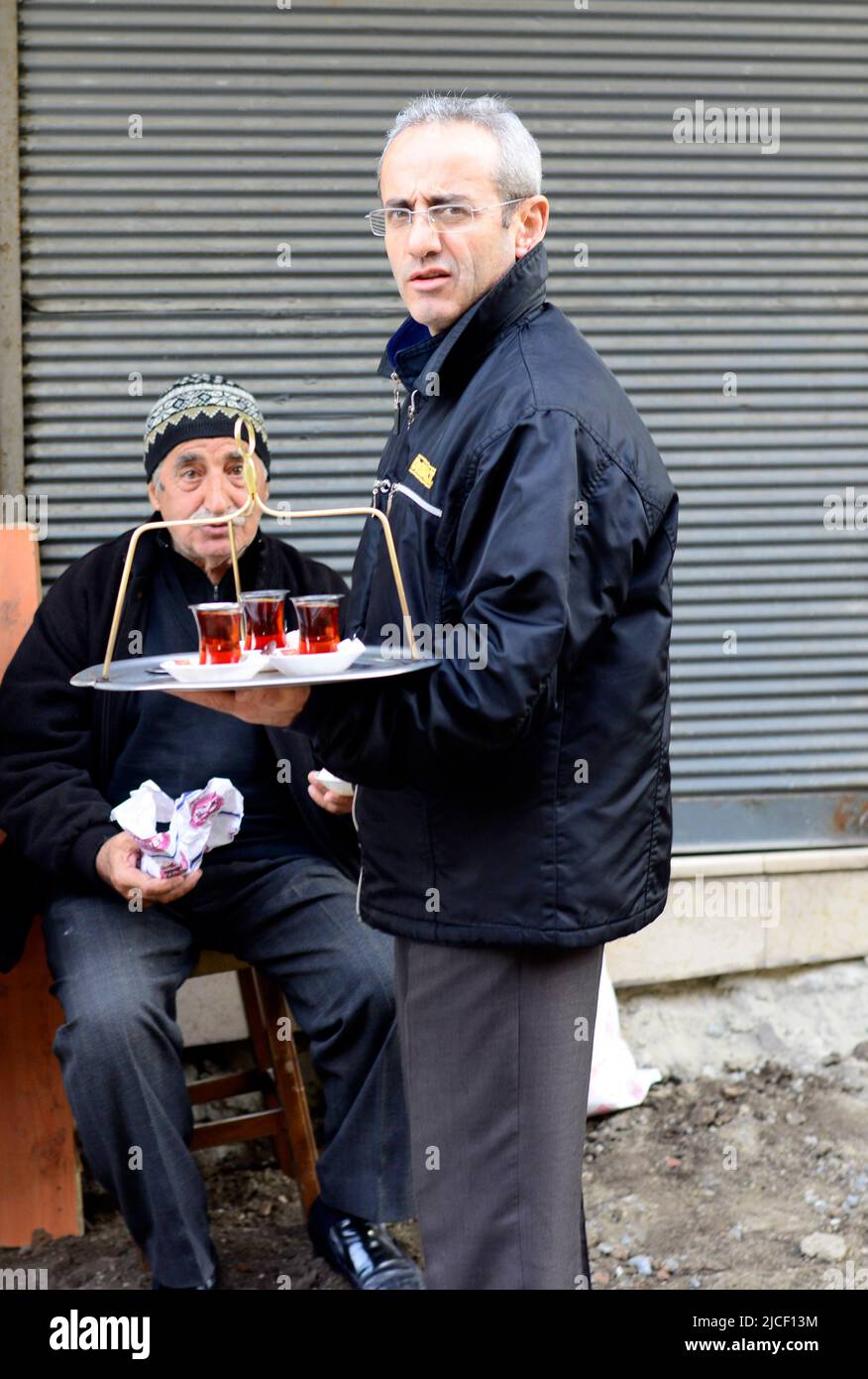 A Turkish man serving tea in a small tea shop in Istanbul, Turkey Stock ...