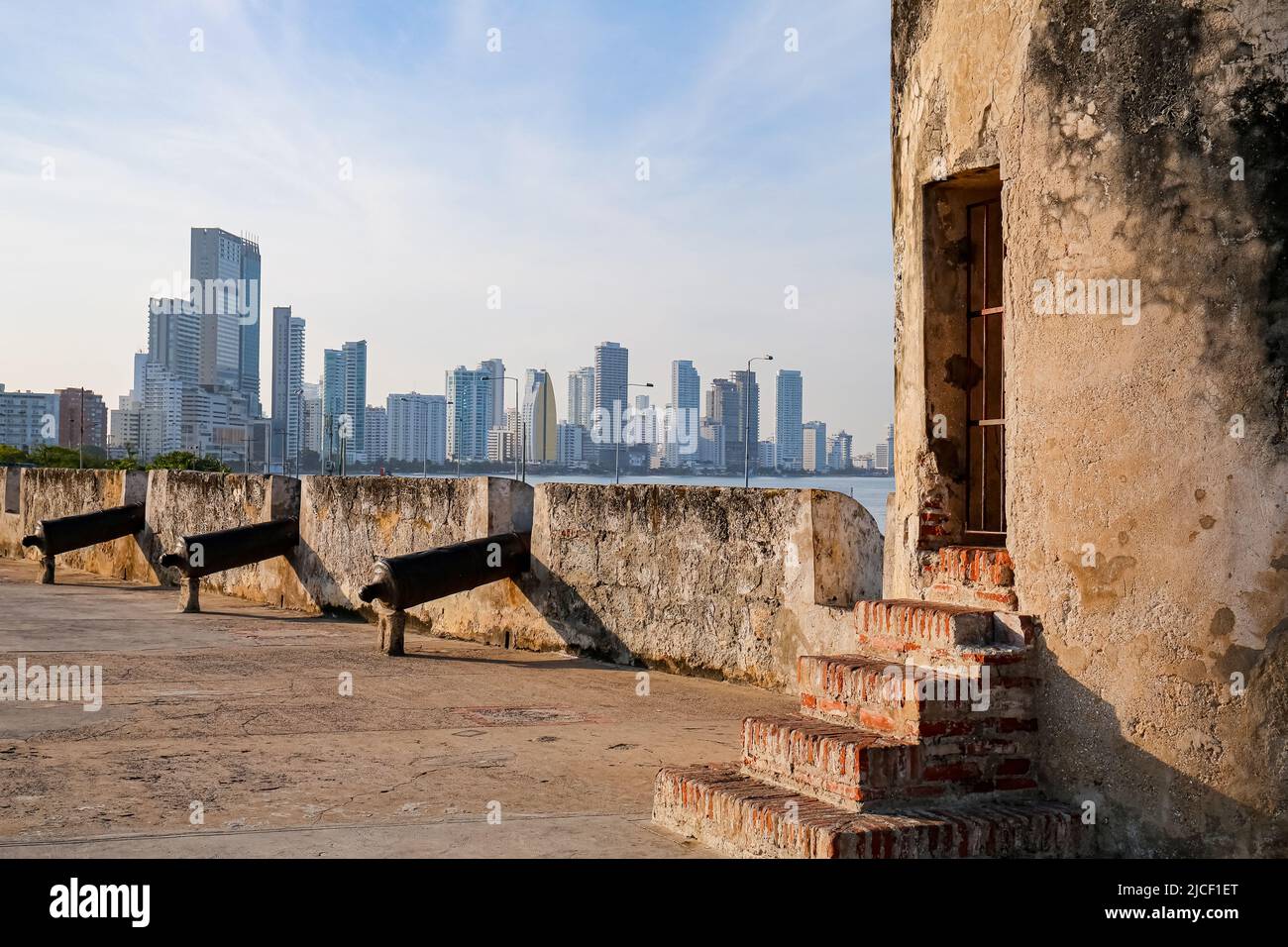 View from city wall with bastion and cannons and the skyline of modern ...