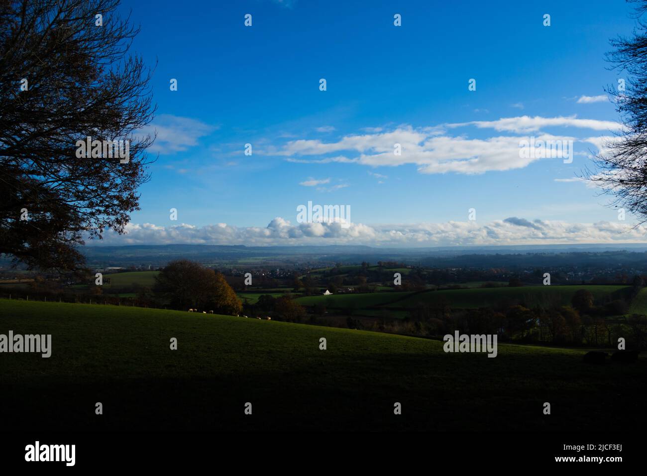 bright sunshine on Devon hills and fields with a slightly hazy and ...