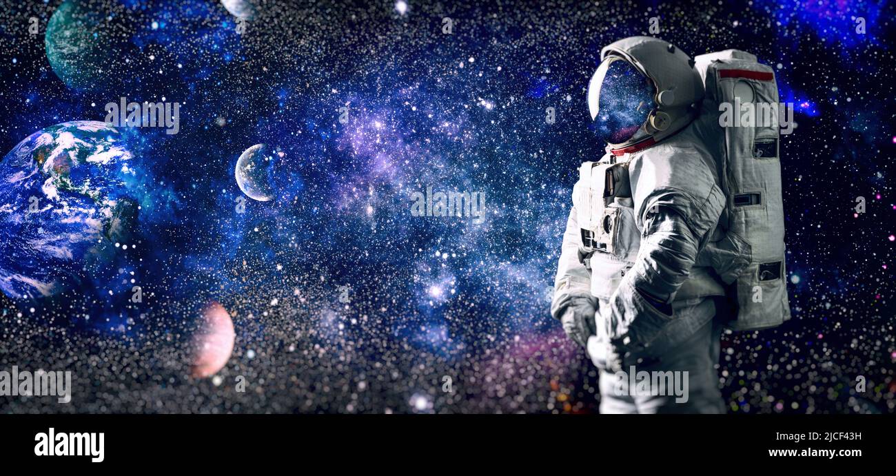 Astronaut in space in the solar system Earth. Blue light on background ...