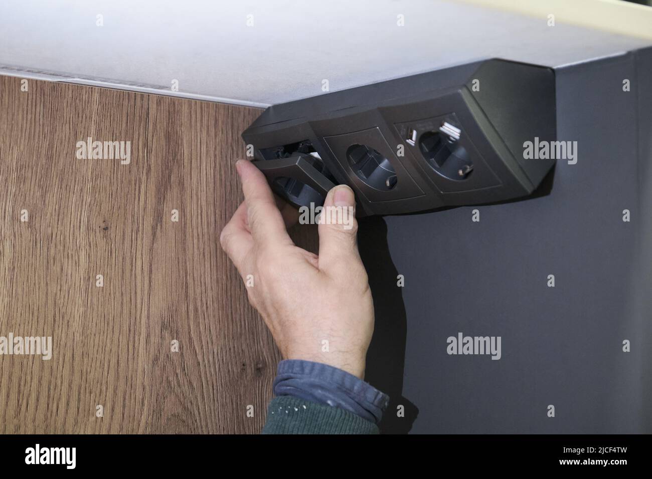 Close up of a man installing corner socket Stock Photo - Alamy