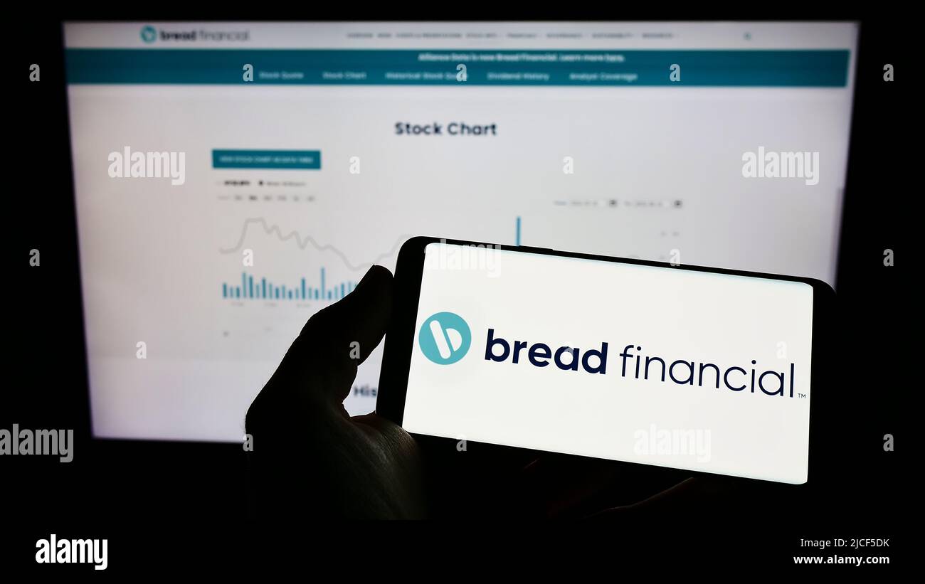 Person holding mobile phone with logo of American company Bread ...