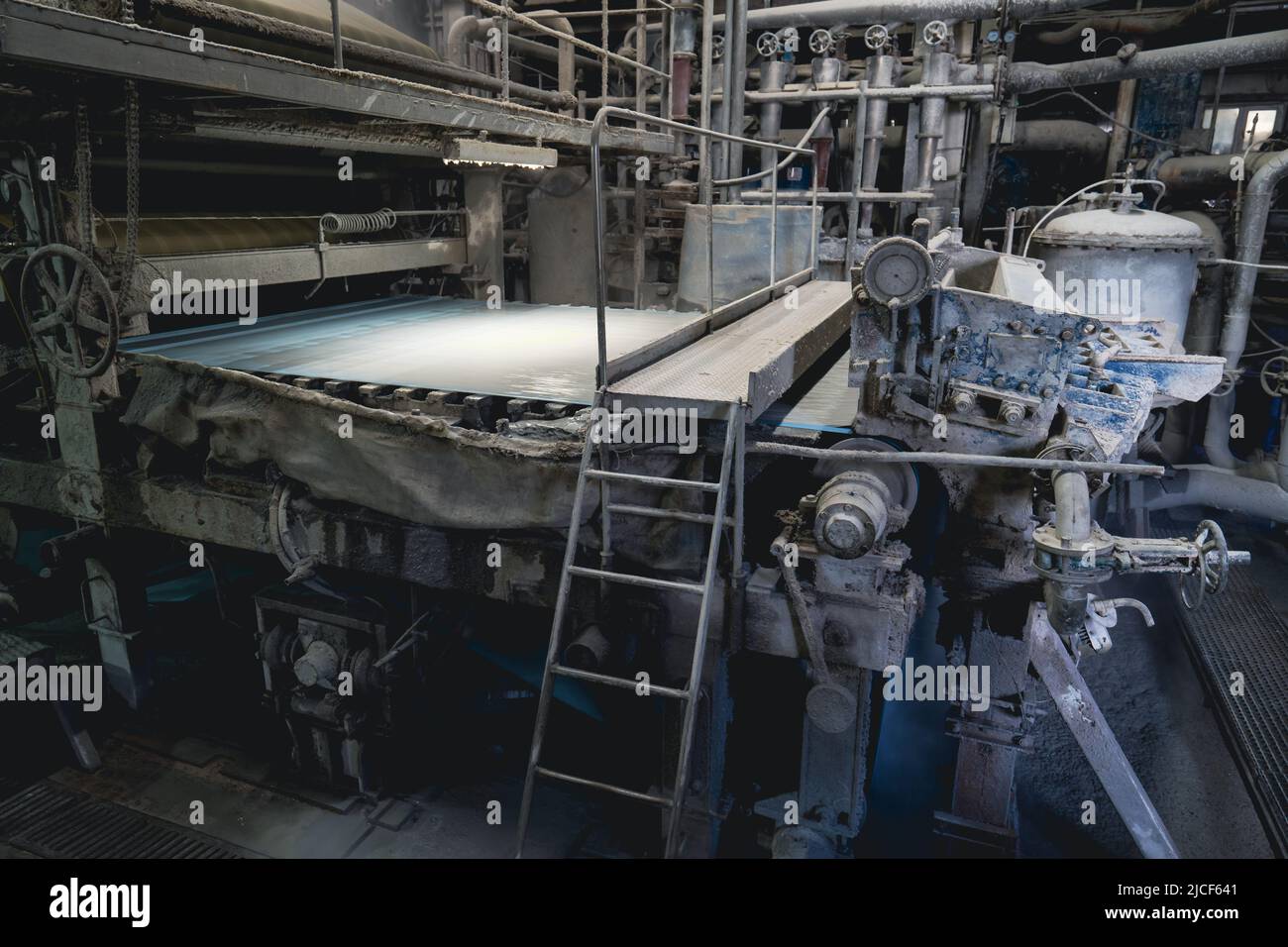 Paper production machine in wastepaper recycling factory. Paper and ...