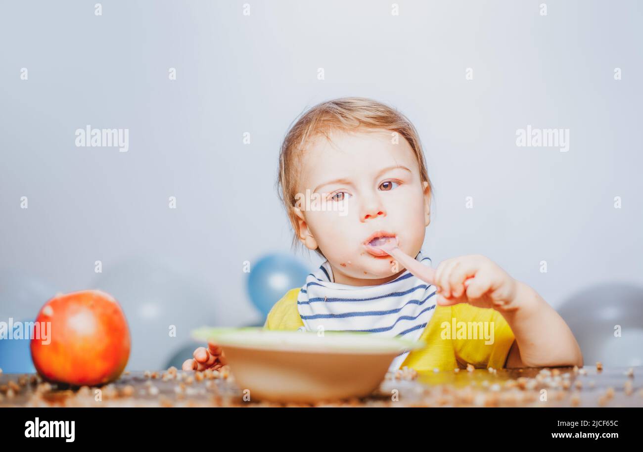 Kid eat healthy nutrition, baby food. Babies eating with spoon. Funny ...