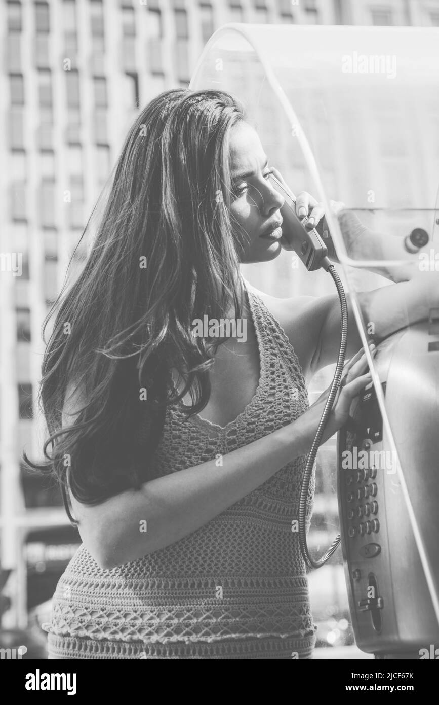 Oldstyled city. Vintage concept. Woman with payphone. Communication ...