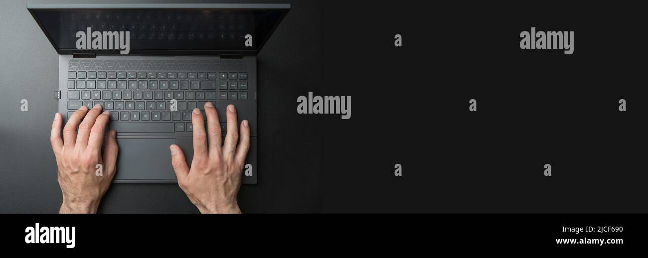 Laptop computer keyboard with user or gamer hands on black stylish ...
