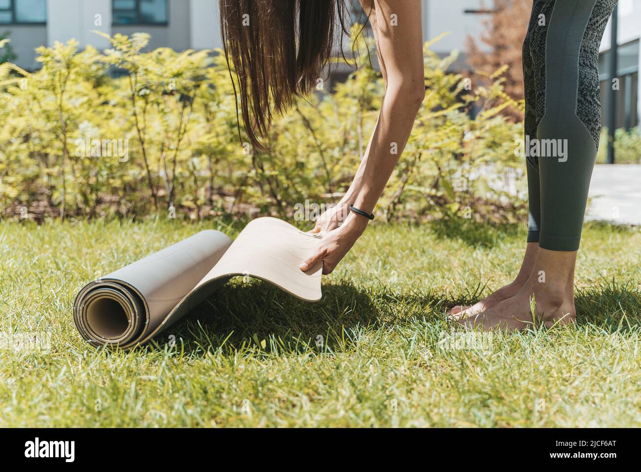 Girl with yoga mat before starting workout practice outdoors. Sport ...