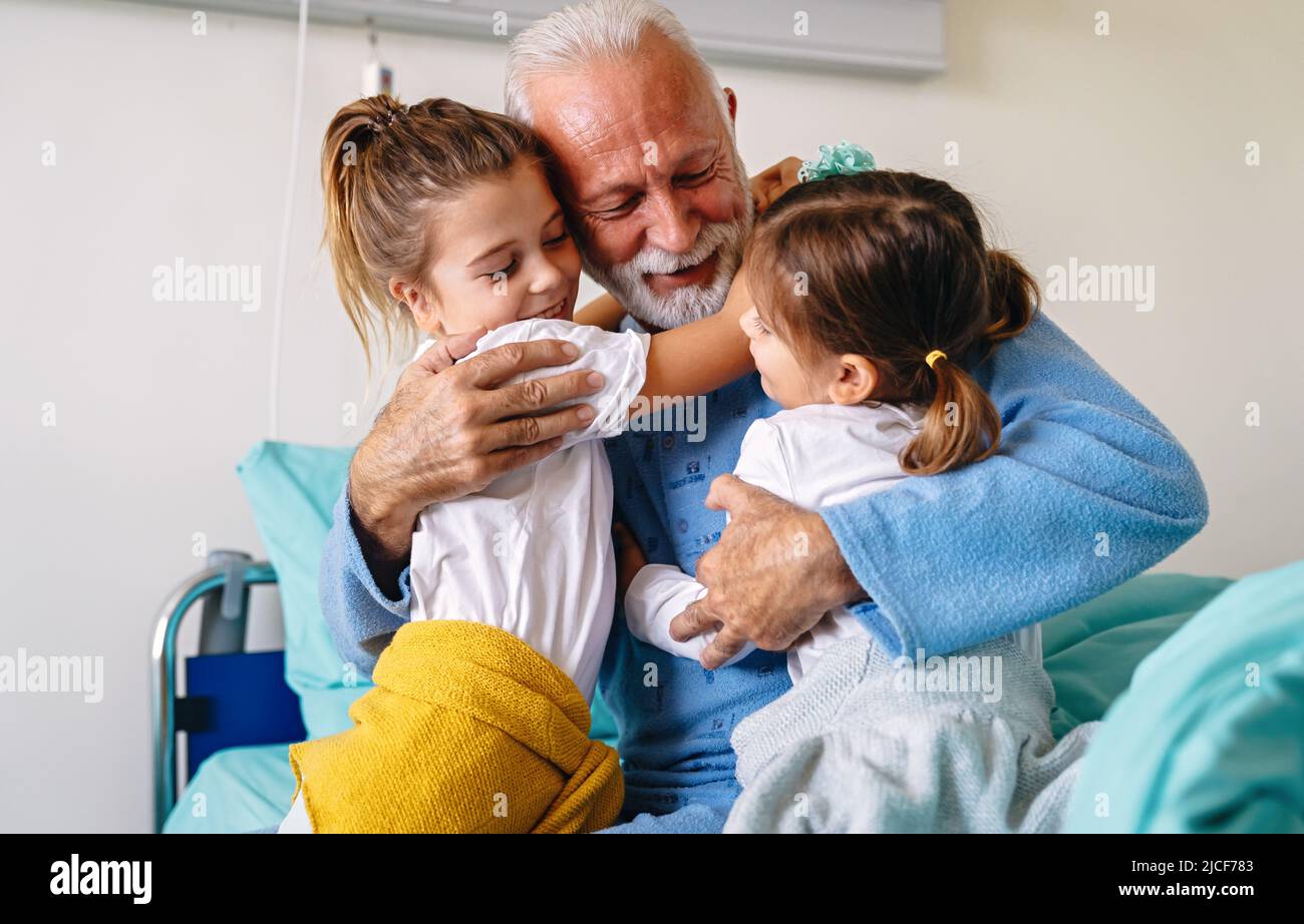 Happy grandfather and his grandchildren laughing and enjoying leisure ...