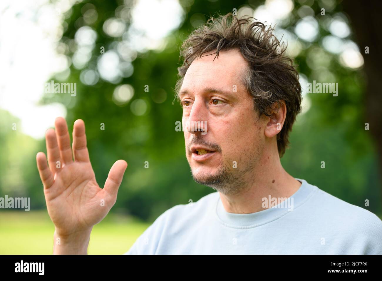 Hamburg, Germany. 11th June, 2022. Actor Hans Löw stands in Jenischpark ...