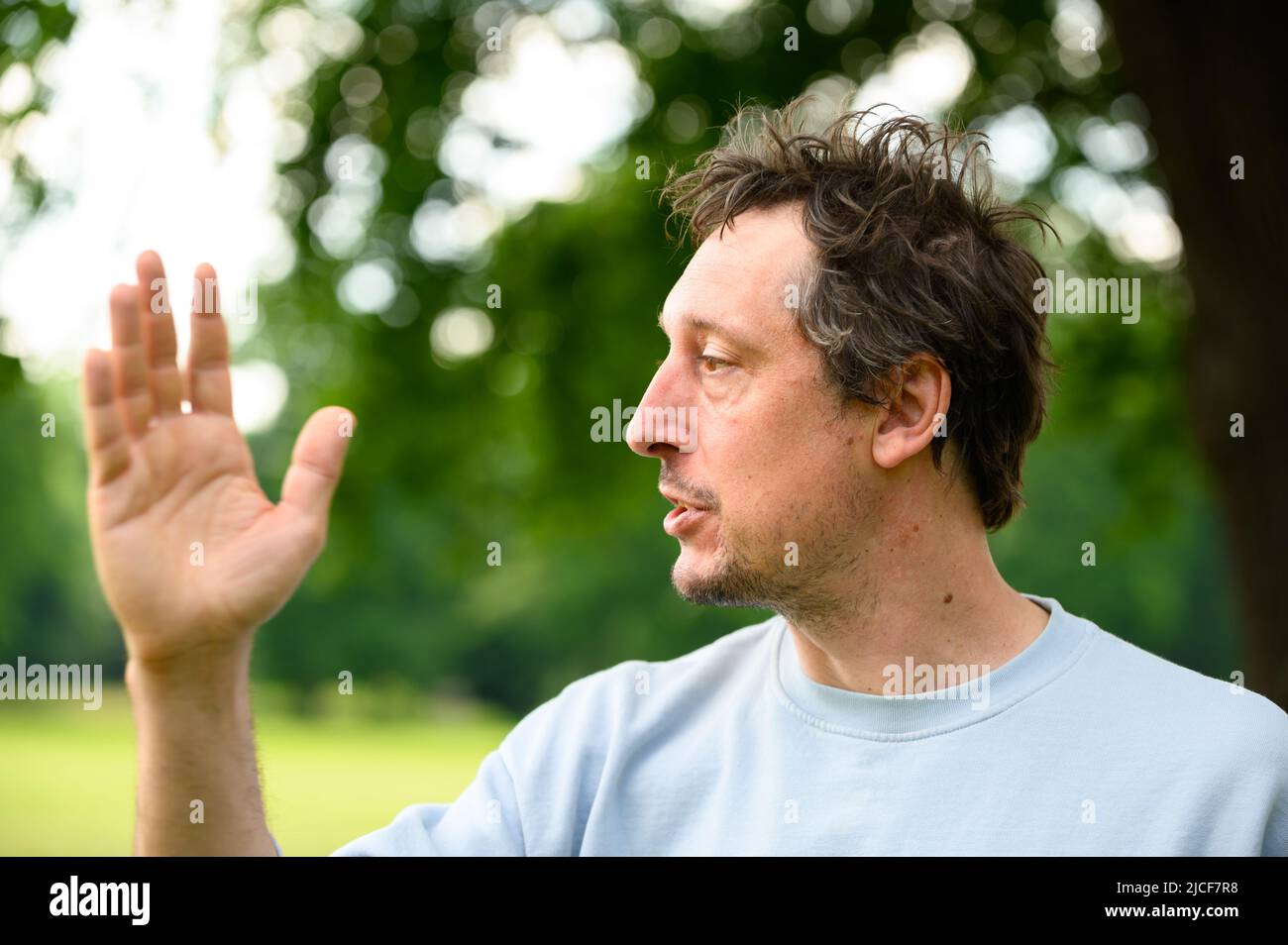 Hamburg, Germany. 11th June, 2022. Actor Hans Löw stands in Jenischpark ...