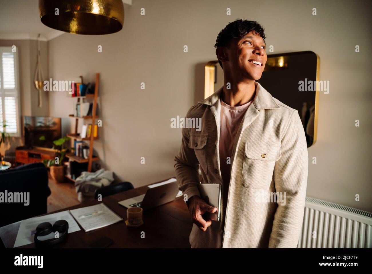 Asian man standing and smiling Stock Photo - Alamy