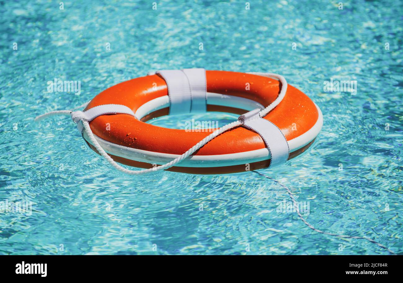 Lifebuoy in a blue sea. Weter help background Stock Photo - Alamy