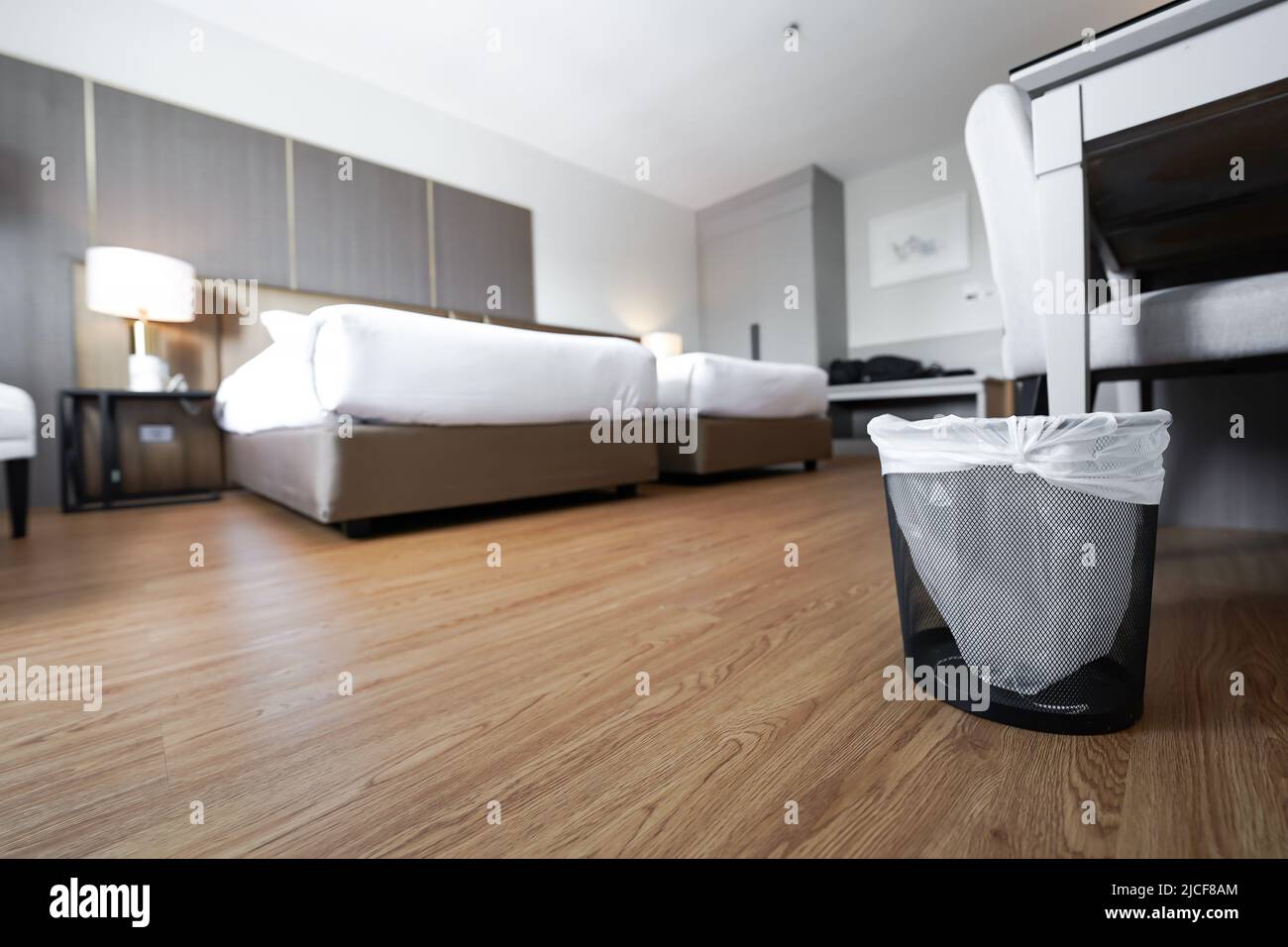 A container trash in the room with plastic inside it in hotel and ...