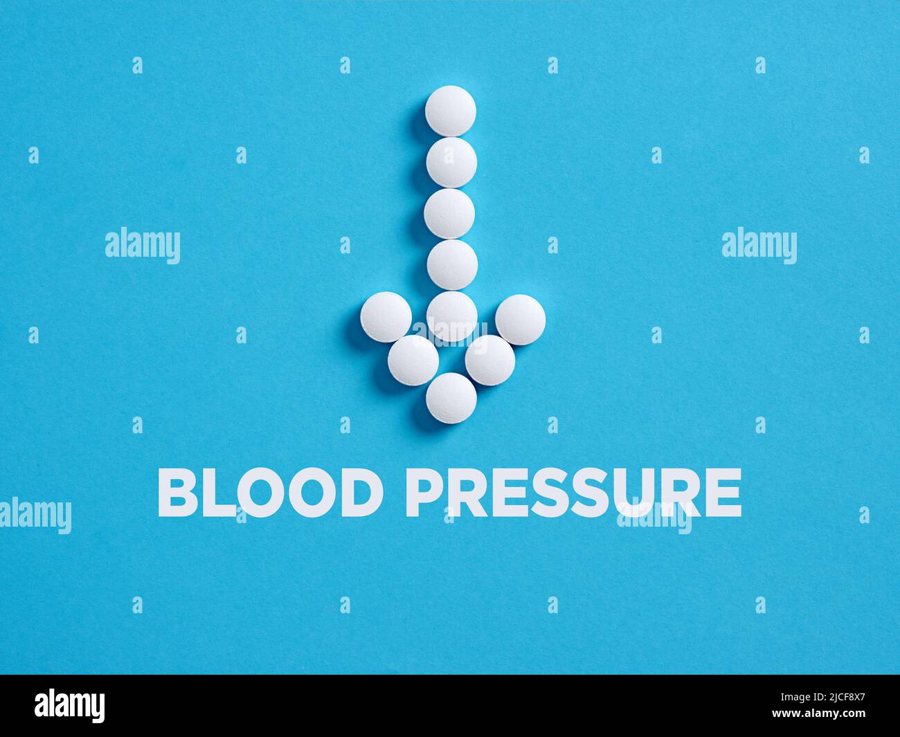 Round white medical pills in arrow shape pointing to the word blood ...