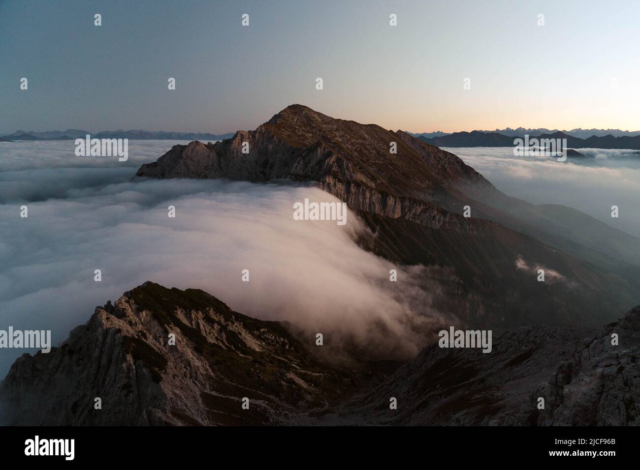 Peak of mountain with sea of clouds - Grignetta (Italy Stock Photo - Alamy
