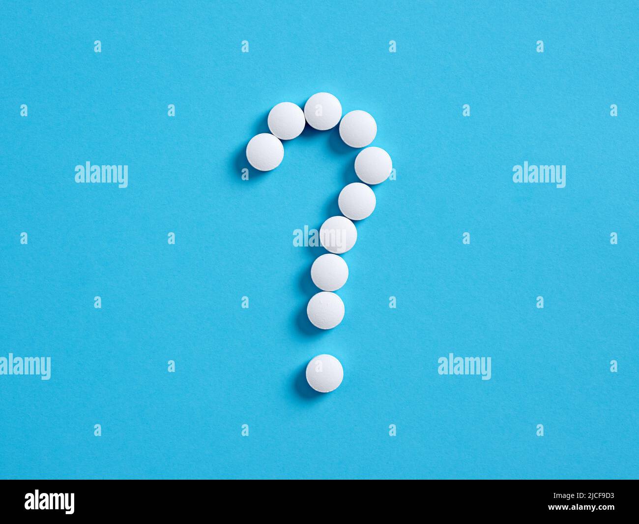 Question mark symbol made of medical pills on blue background. Medical ...