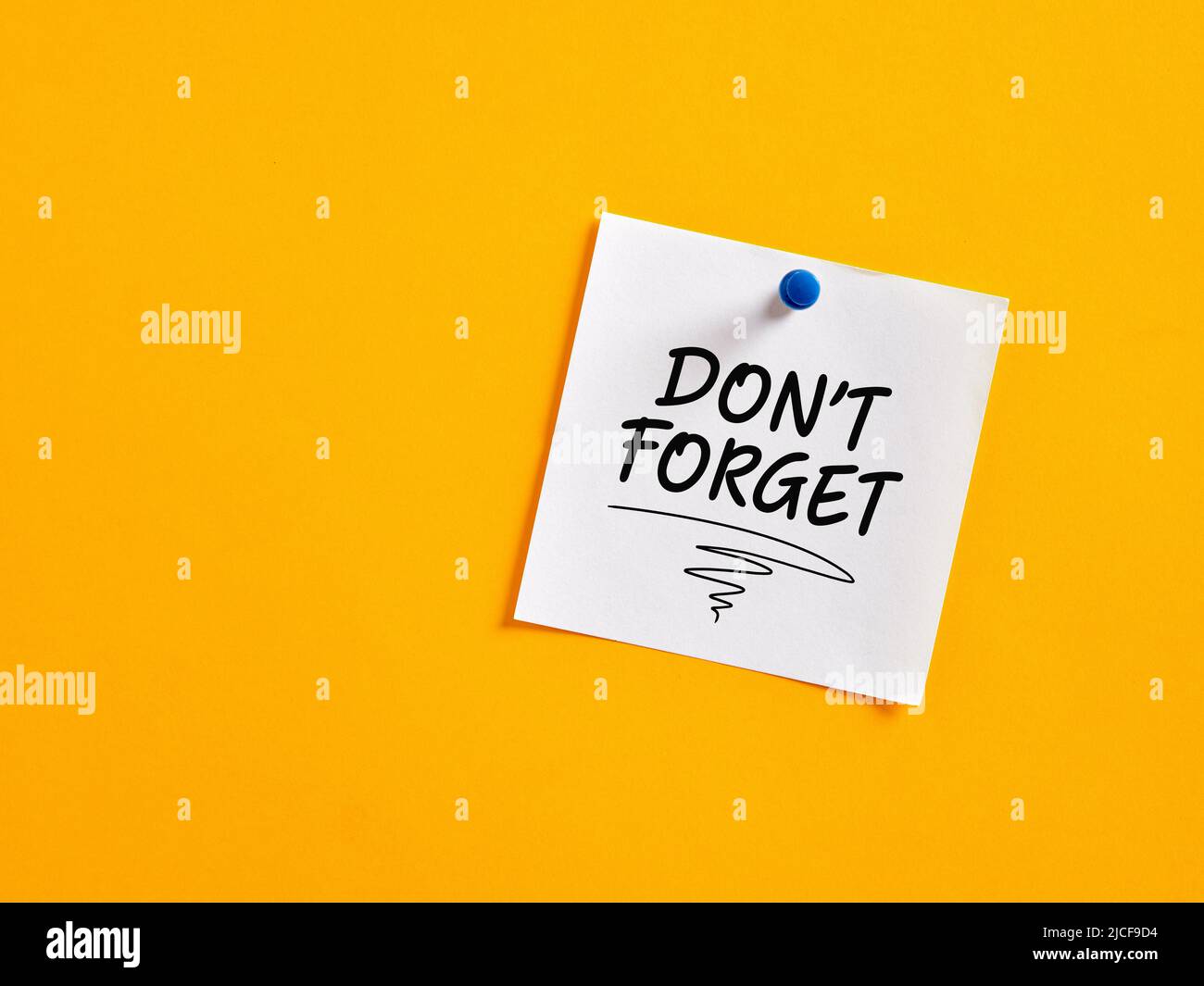 The notice reminder don't forget written on a note paper pinned on a ...