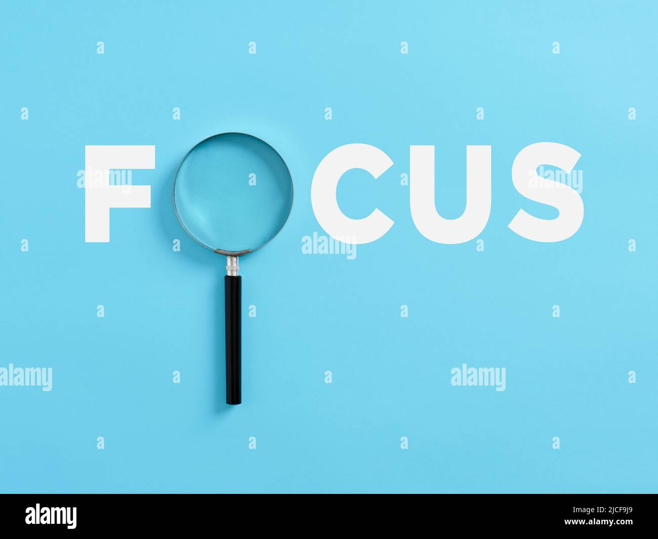 The word focus with a magnifying glass. Focusing on a target in ...