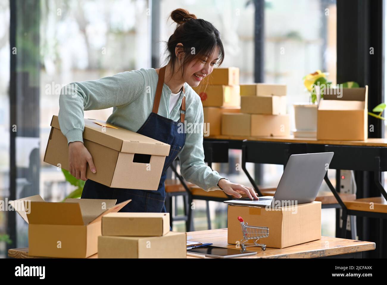 Startup small business owner wearing apron working at home office ...